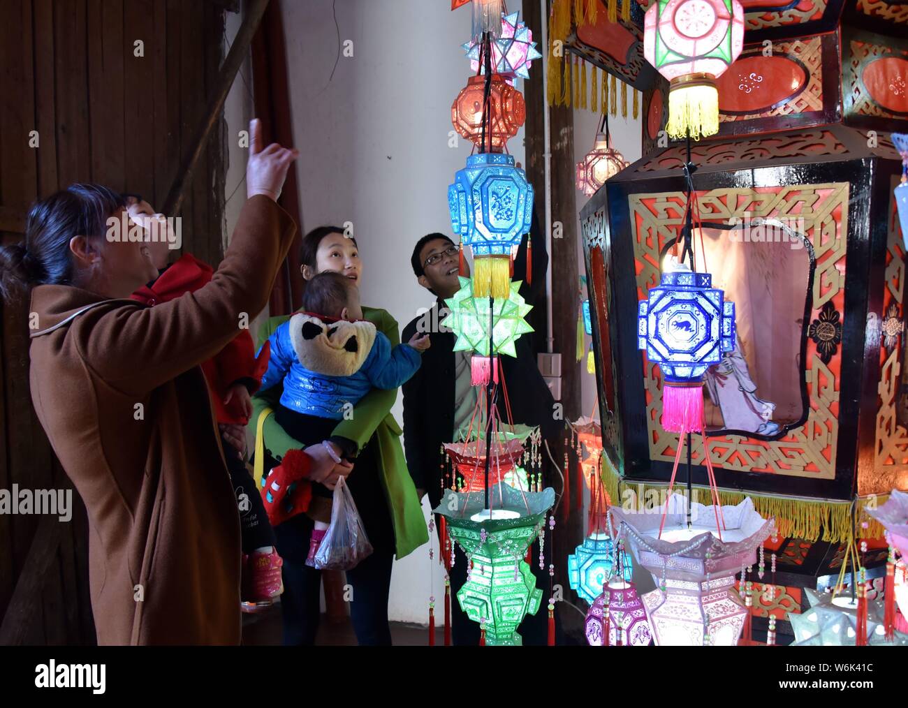 Visitors look at lanterns made by Chinese craftsman Chen Caiping for ...
