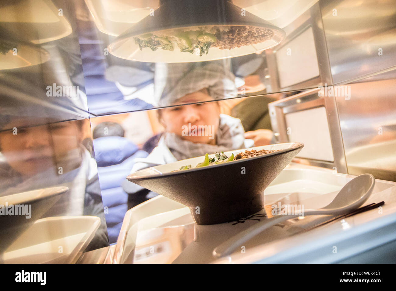 A customer gets her food from the food pick-up window at the first ...