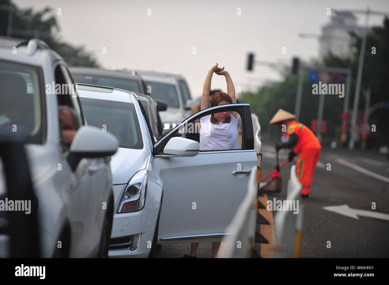 People get off their cars to take a rest as masses of vehicles line up ...