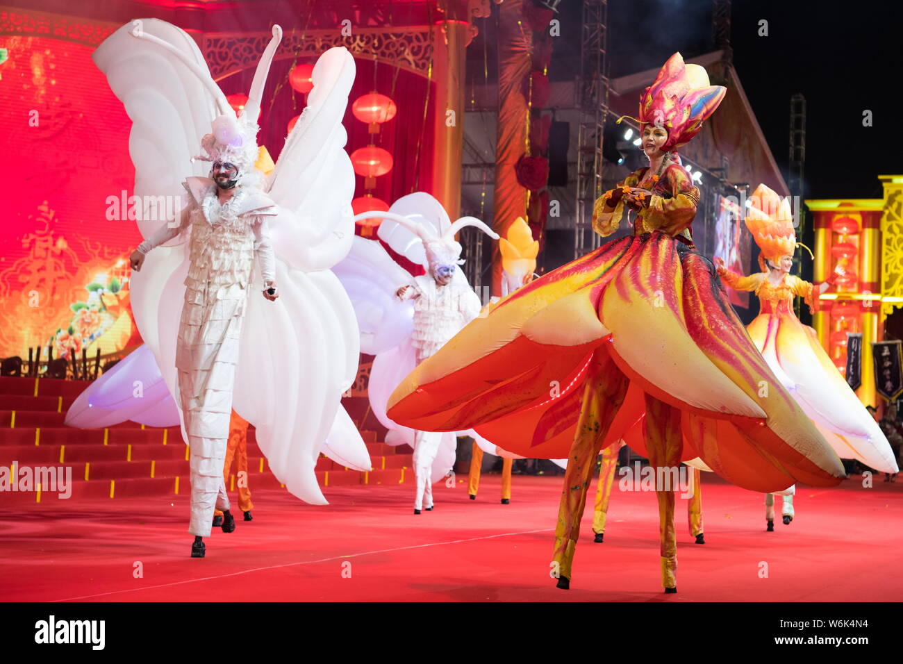 Performers walk on stilts while taking part in a parade to celebrate ...