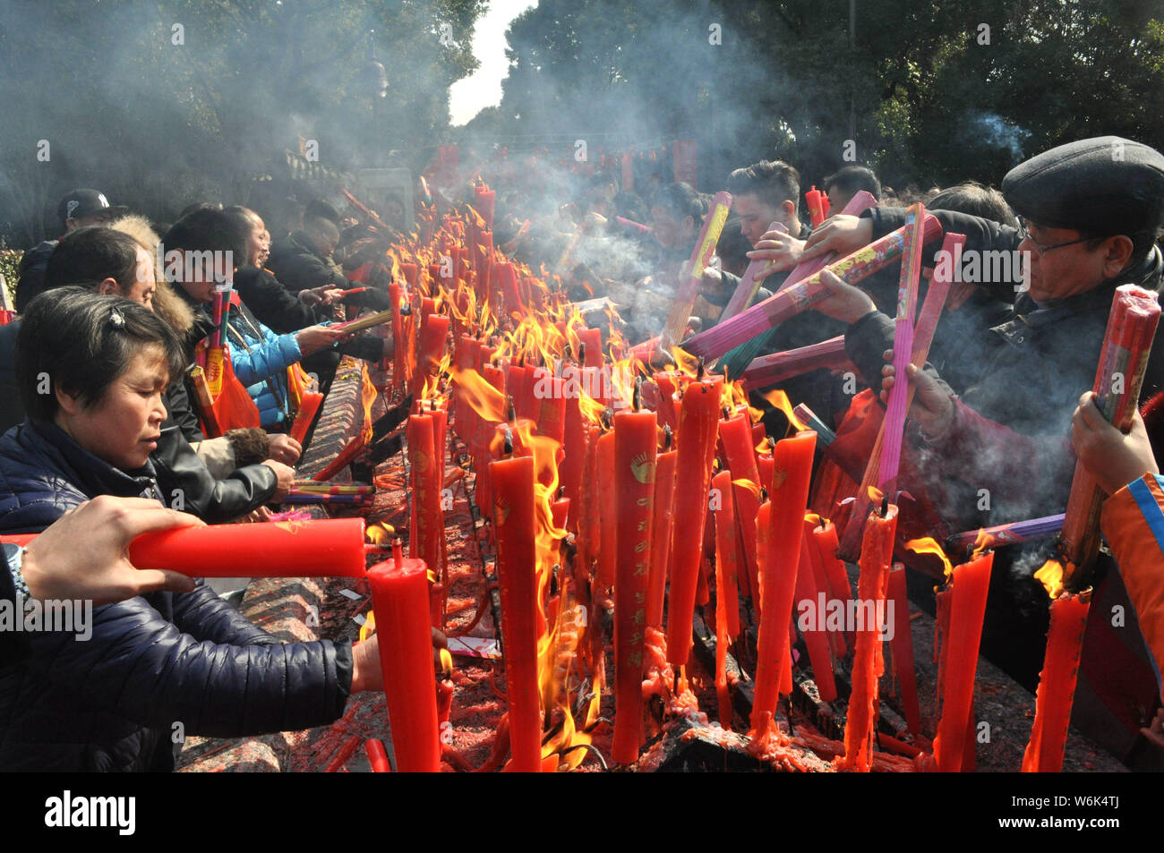 Chinese worshippers burn incense sticks to pray for good luck on the ...