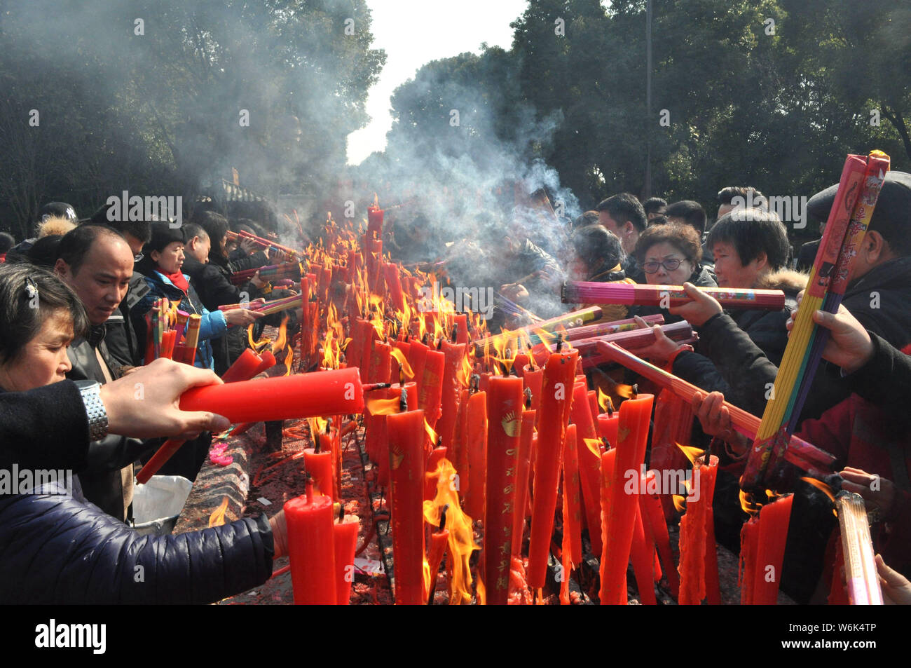 Chinese worshippers burn incense sticks to pray for good luck on the ...