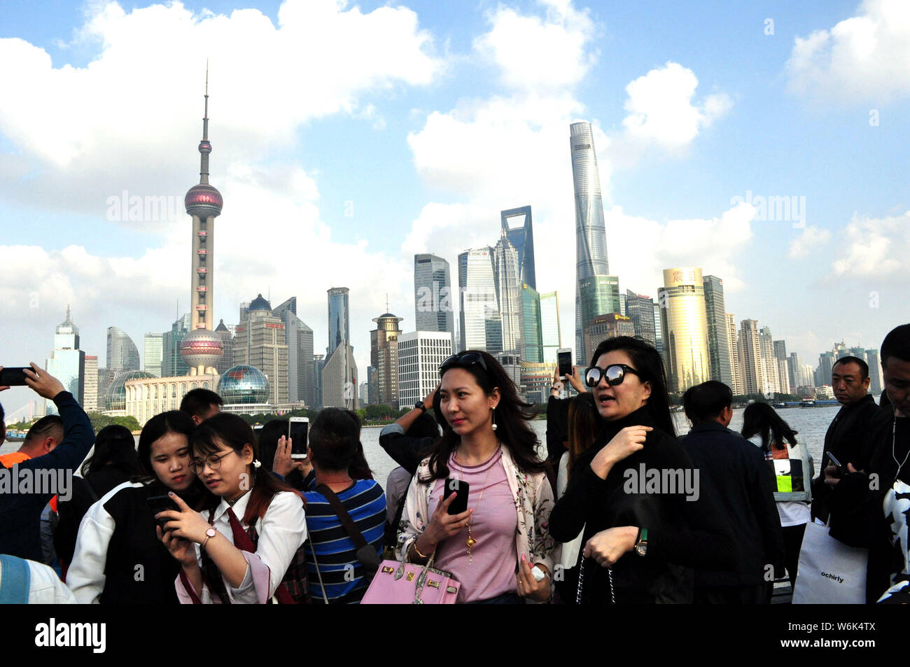 --FILE--Tourists crowd the promenade on the Bund along the Huangpu ...