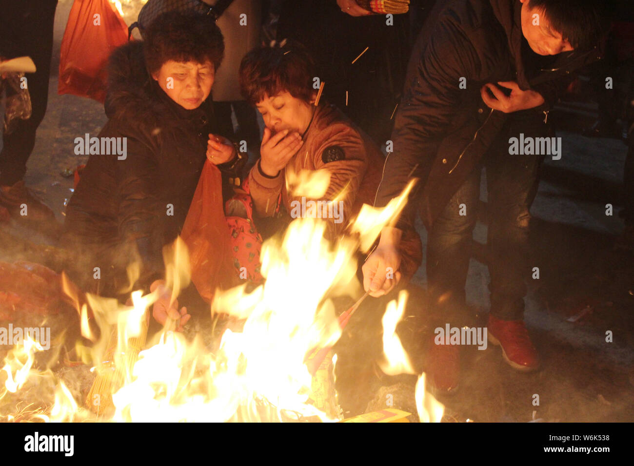 Chinese worshippers burn incense sticks to pray for wealth and ...