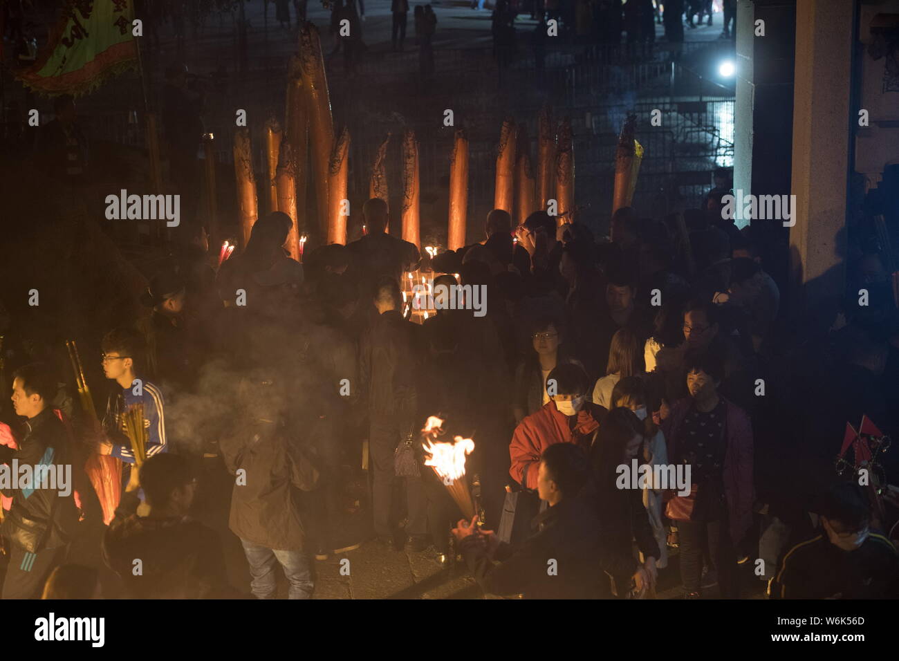 Chinese worshippers burn incense sticks to pray for good luck before ...