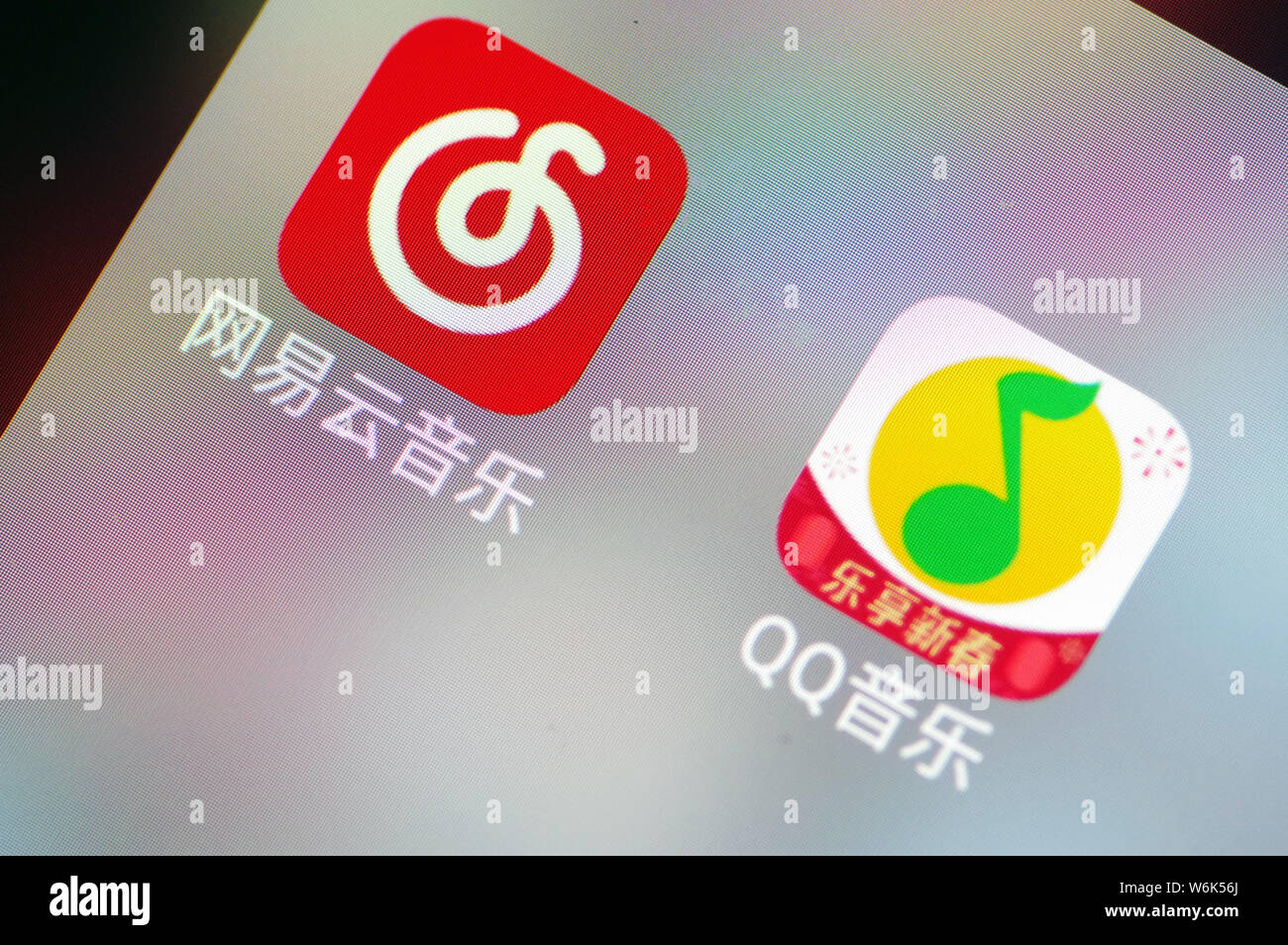 A Chinese mobile phone user looks at the mobile apps of NetEase Music ...