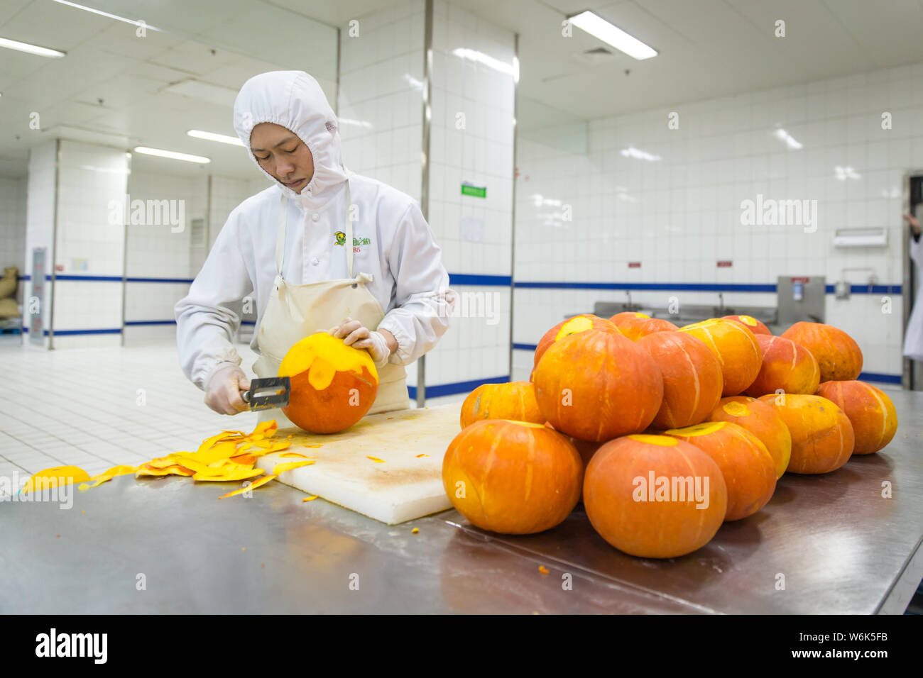 A Chinese worker processes pumpkins at a food processing plant of ...