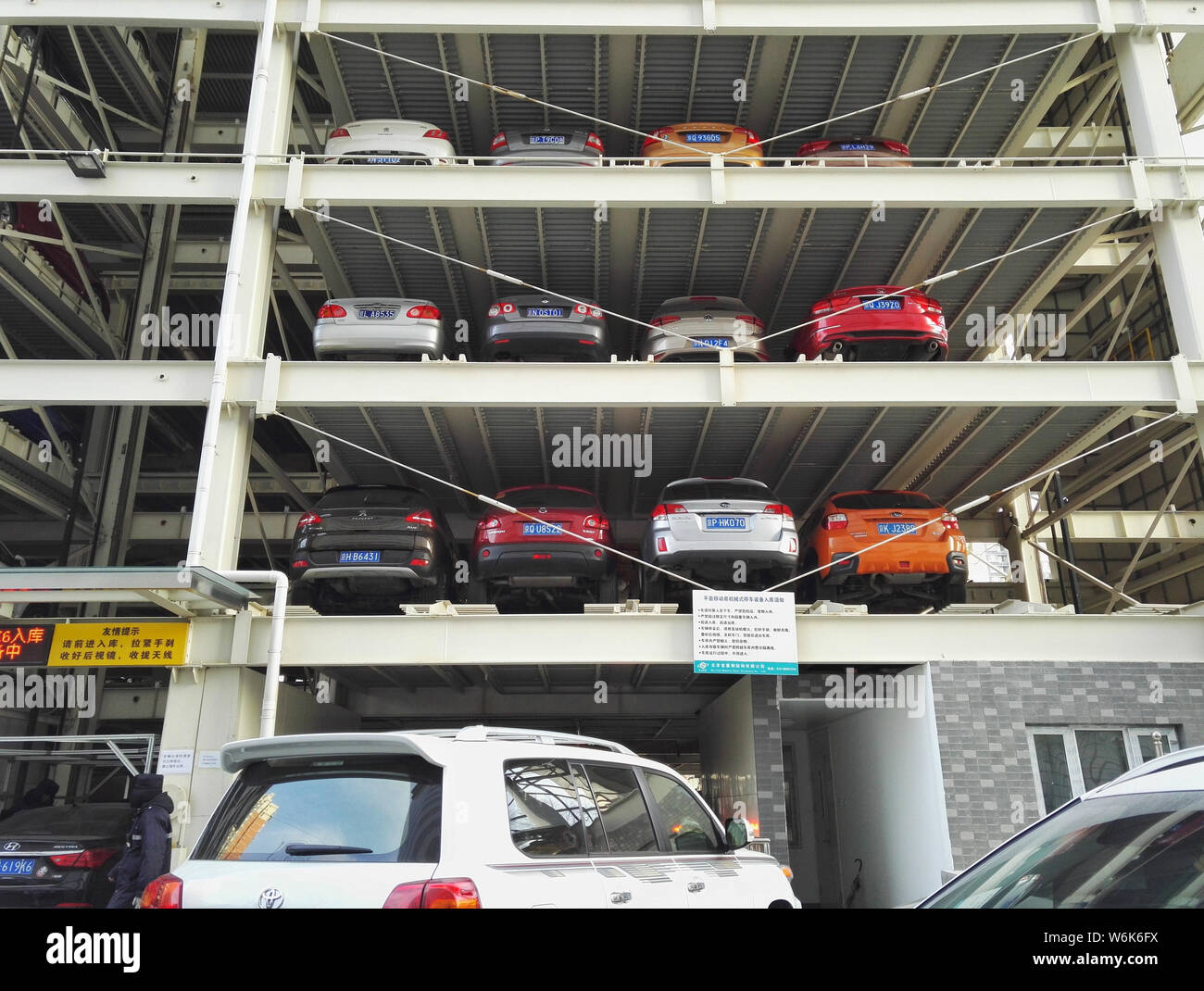 Chinese drivers queue up to park their cars in an automated stacked ...
