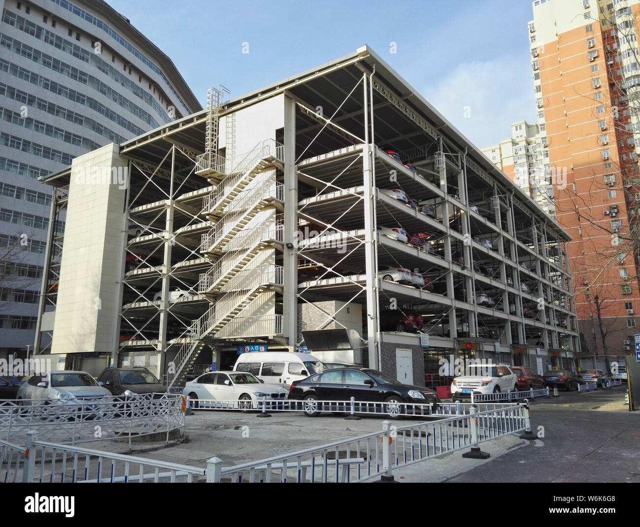 Chinese drivers queue up to park their cars in an automated stacked ...