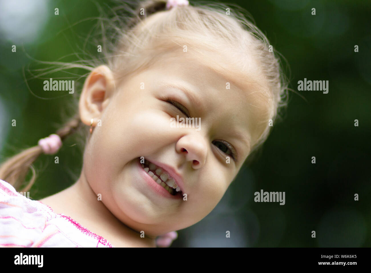 Girl winking close up hi-res stock photography and images - Alamy