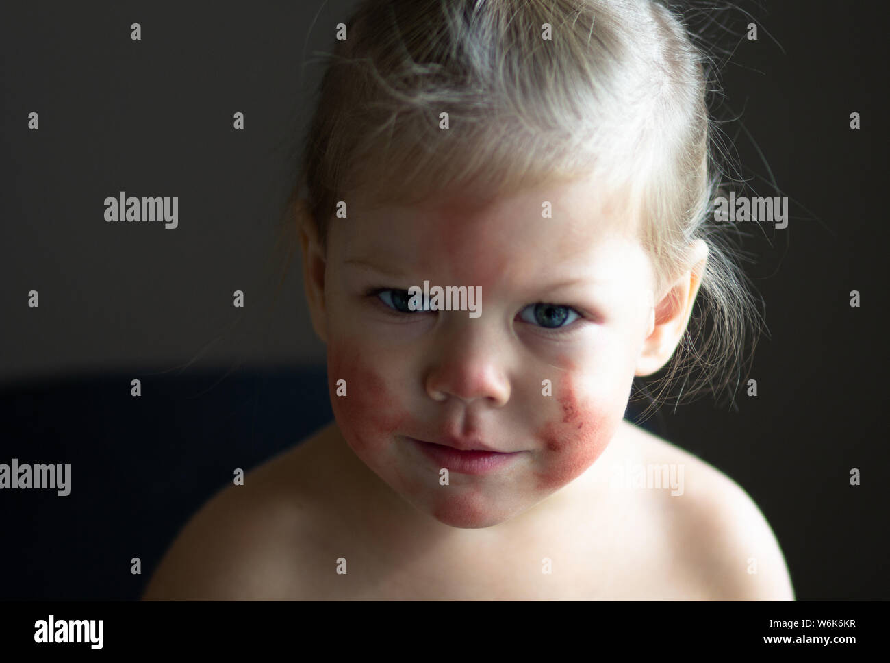 Child applying rouge making up on her face Stock Photo - Alamy