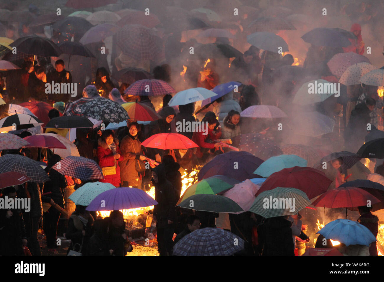 Chinese worshippers burn incense sticks to pray for wealth and ...