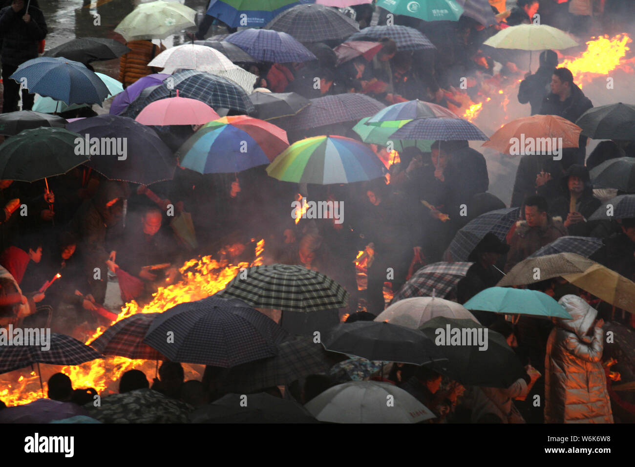 Chinese worshippers burn incense sticks to pray for wealth and ...