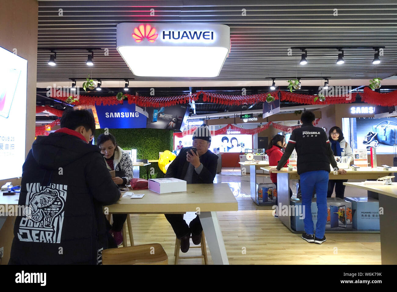 --FILE--People visit the stand of Huawei during an exhibition in ...
