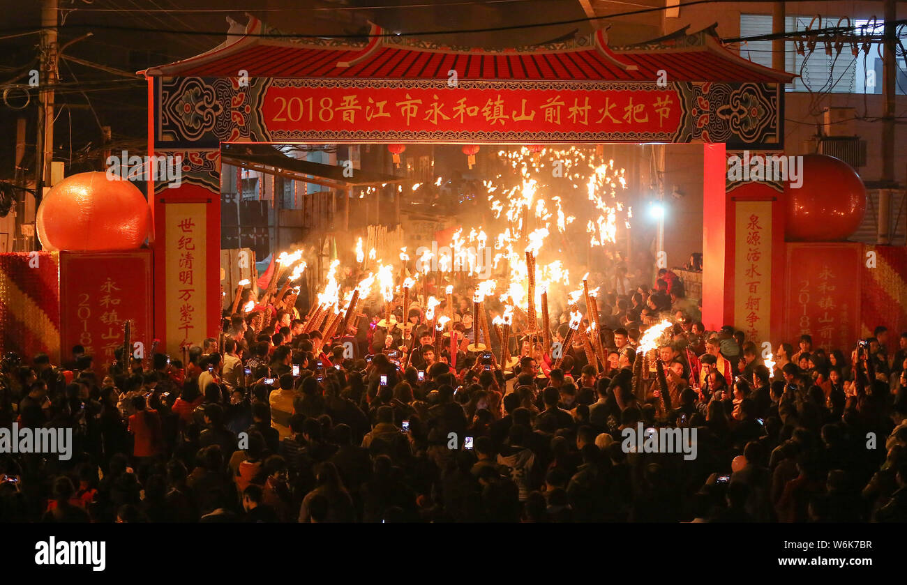 Local villagers take part in a parade for the Torch Festival or Fire ...