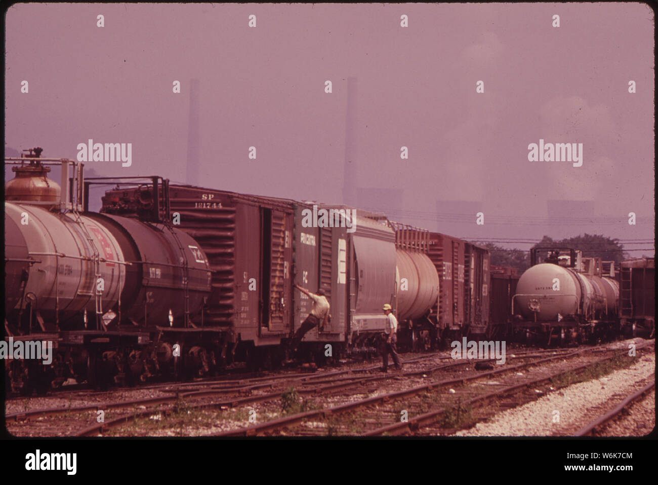 RAILROAD YARDS AT NITRO. THE TALL SMOKESTACKS AND COOLING TOWERS OF THE ...