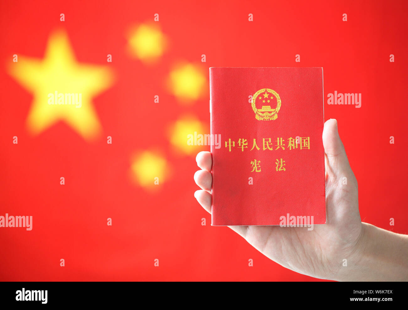 A local Chinese man shows a publication of China's Constitution in ...