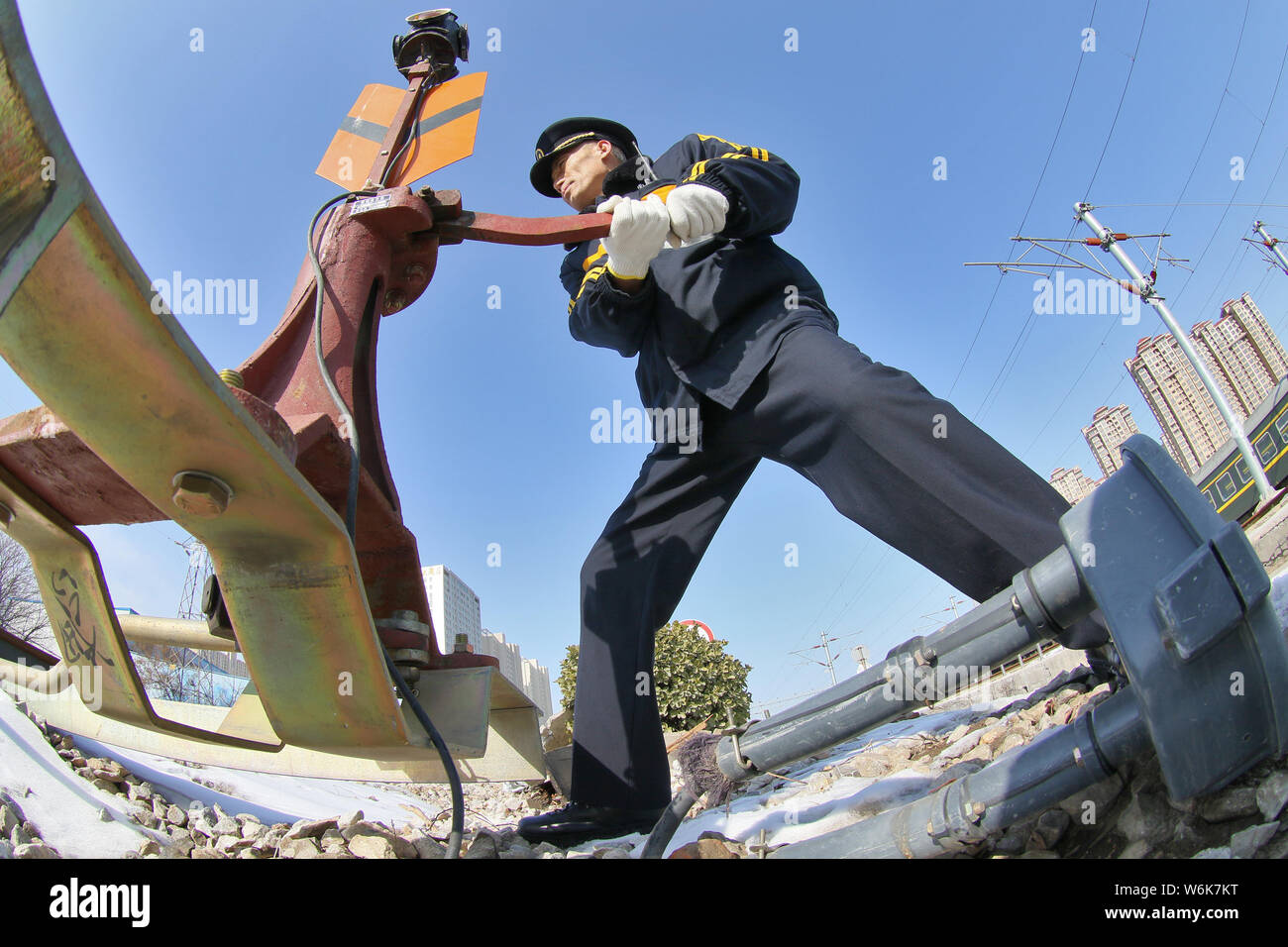 57-year-old Chinese switchman Liu Jun labors at the passenger train ...