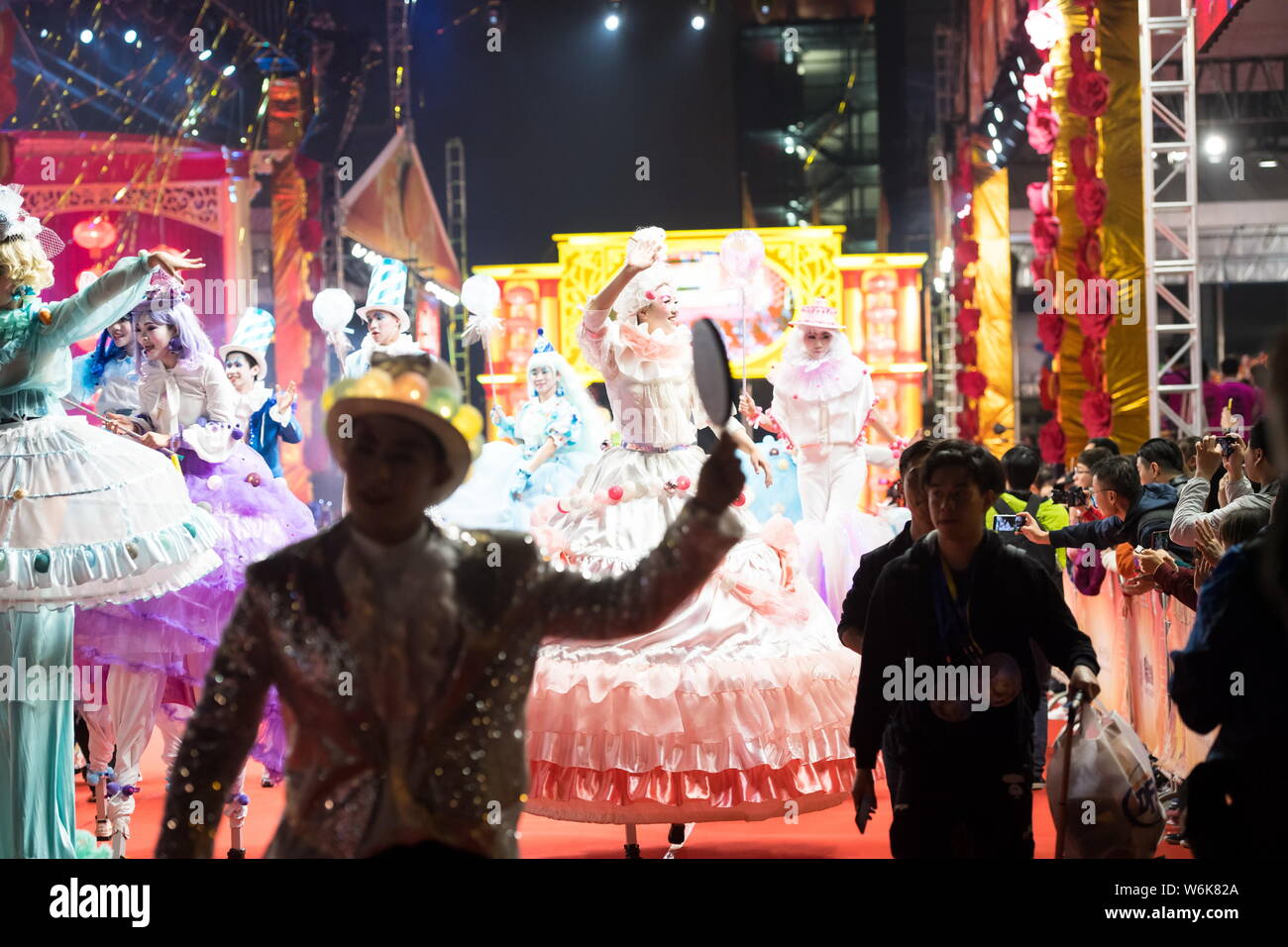 Performers walk on stilts while taking part in a parade to celebrate ...
