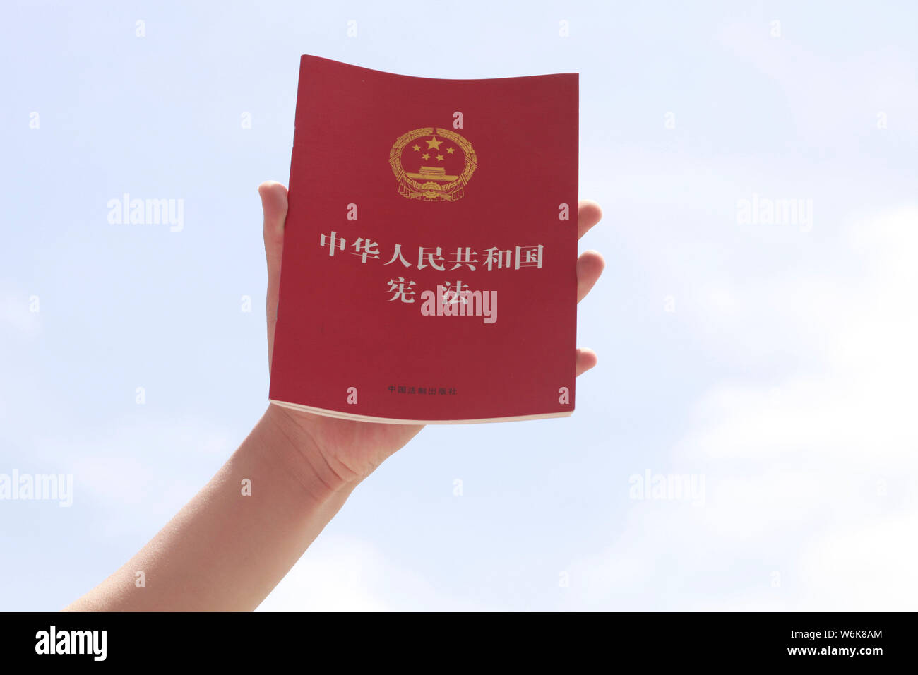 A local Chinese man shows a publication of China's Constitution in ...