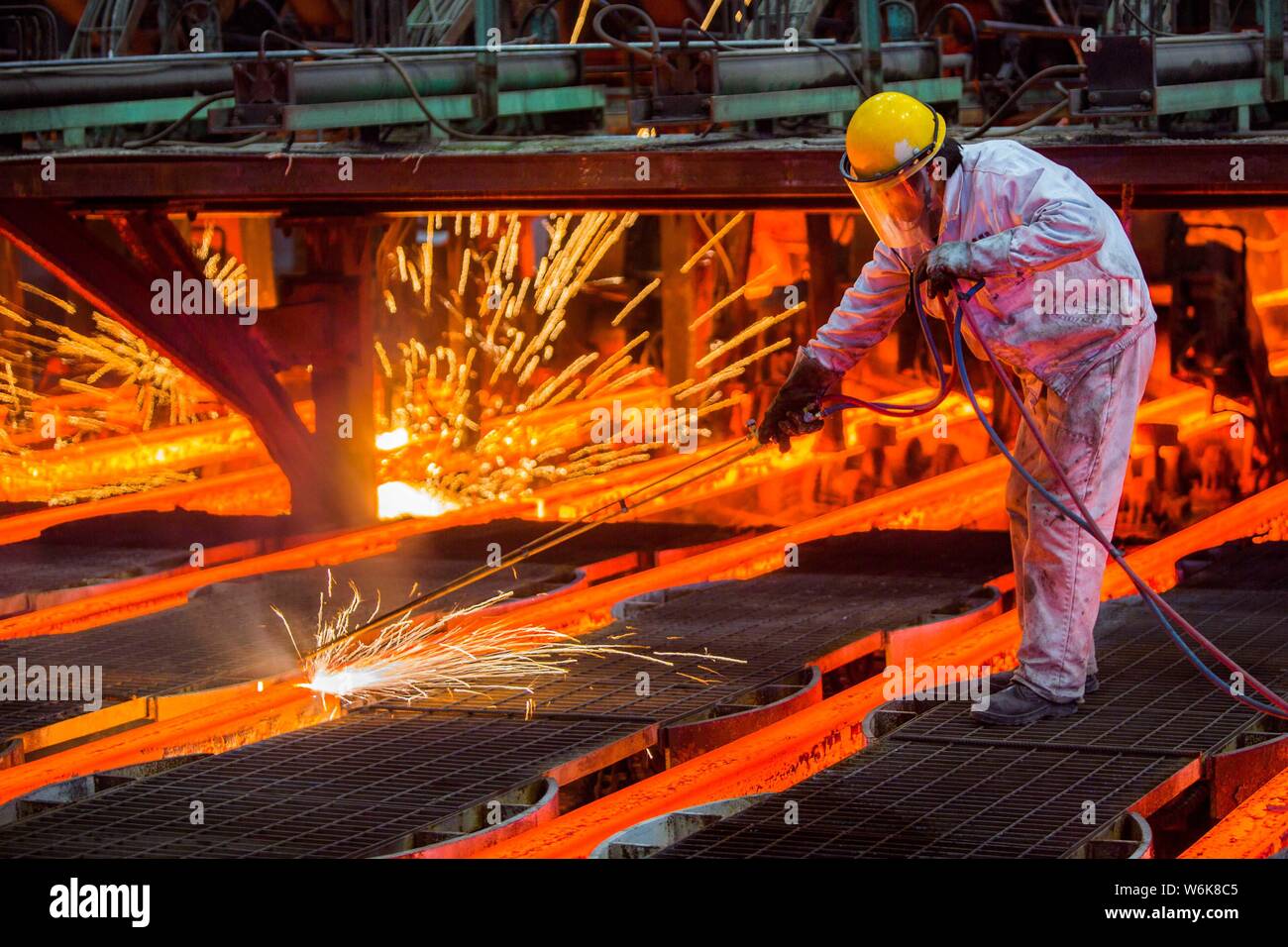 --FILE--A Chinese worker produces steel product at a steel plant in ...