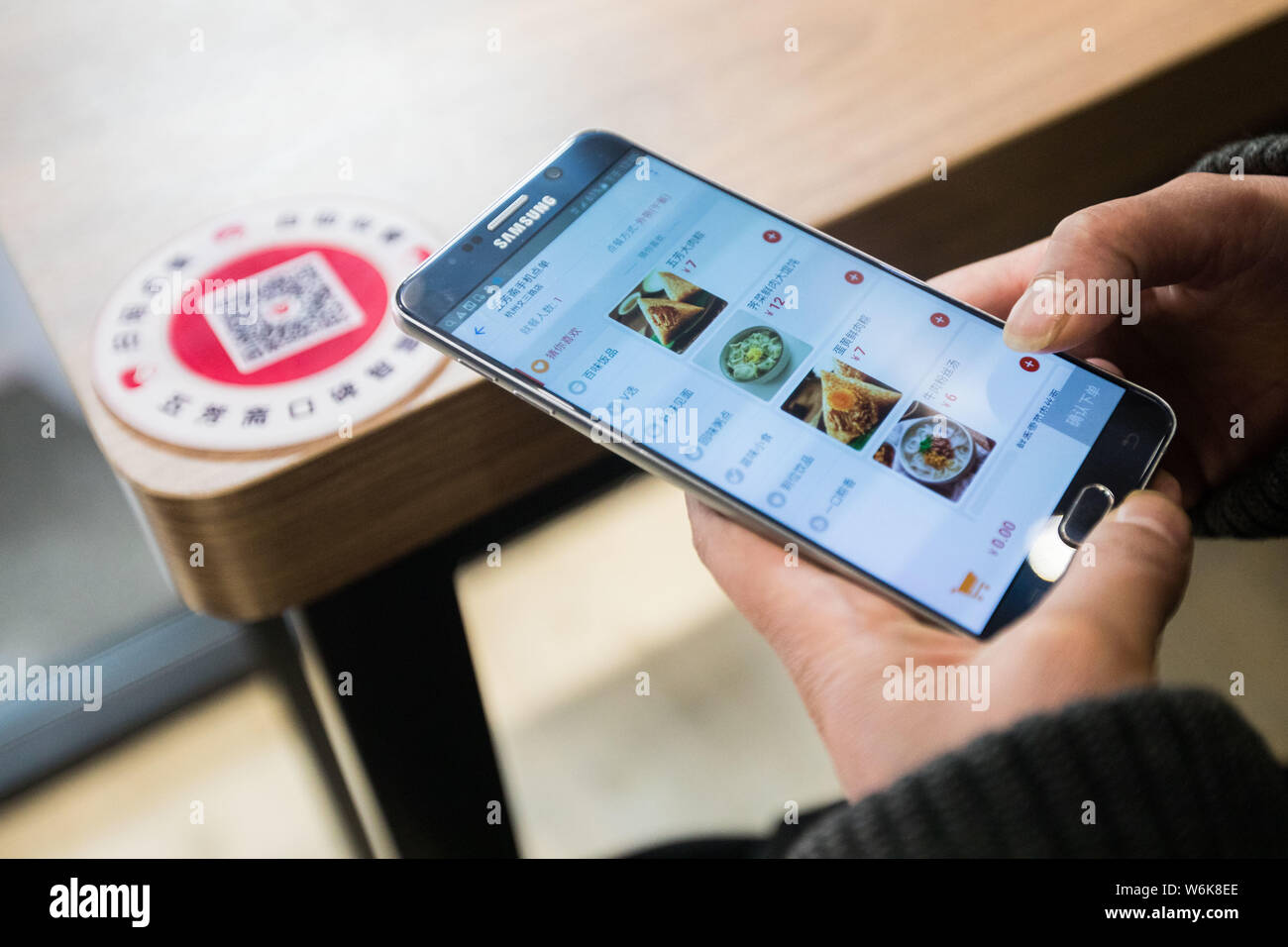A customer order meals on his smartphone at the first automated ...