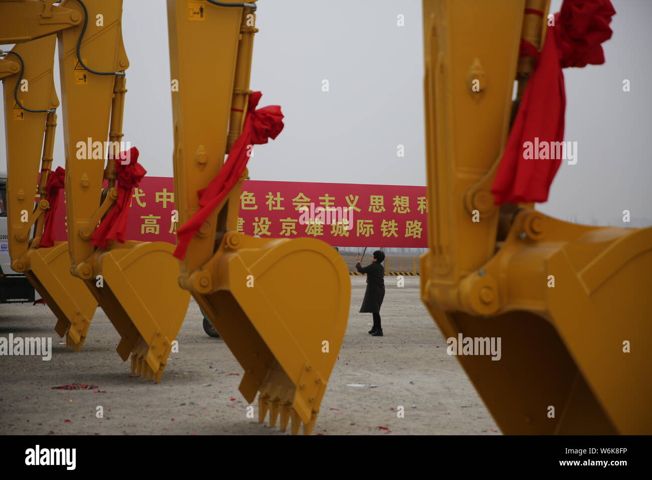 Construction vehicles are standby at the construction site of a rail ...