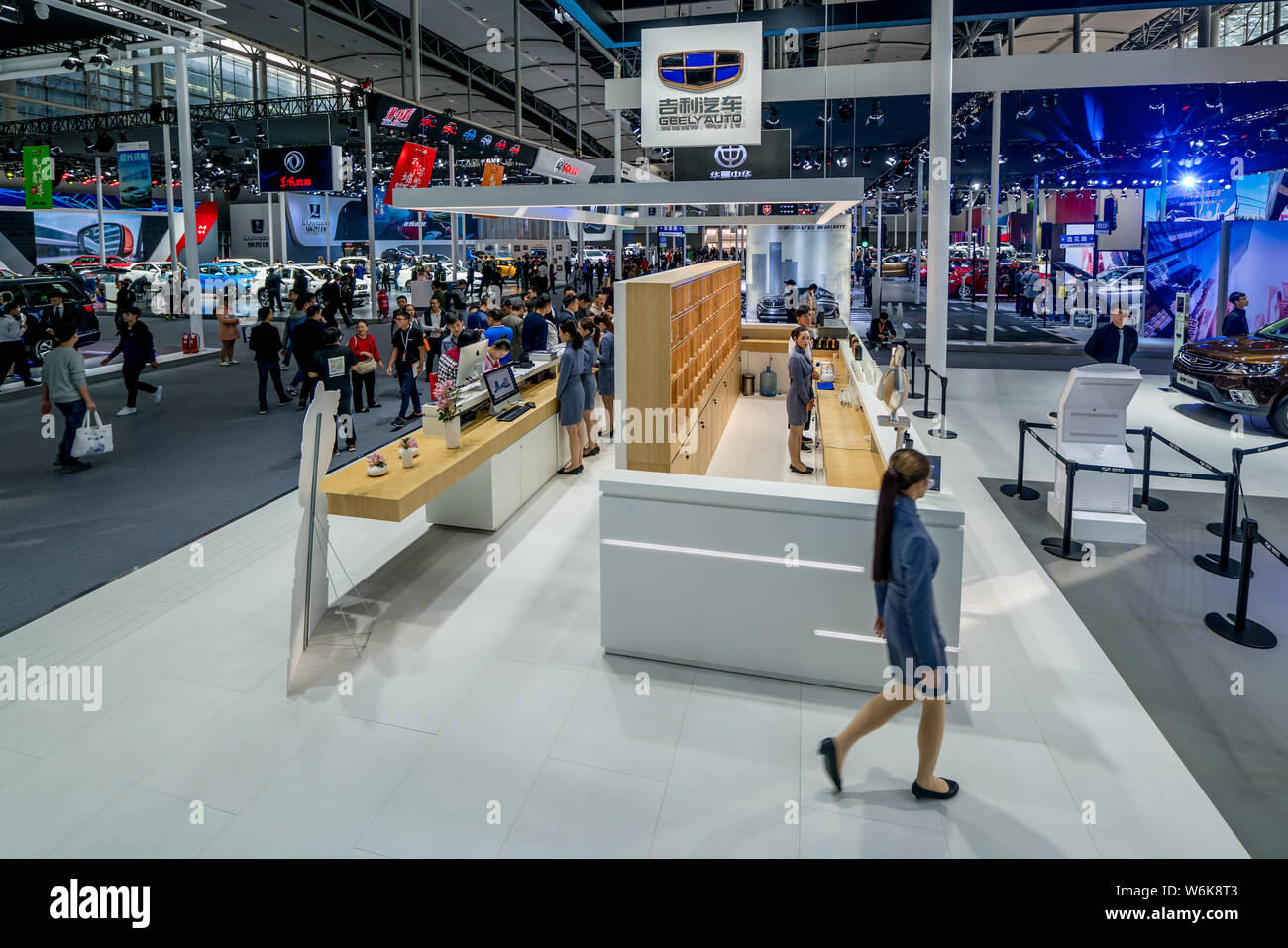 --FILE--People visit the stand of Geely during the 15th China ...