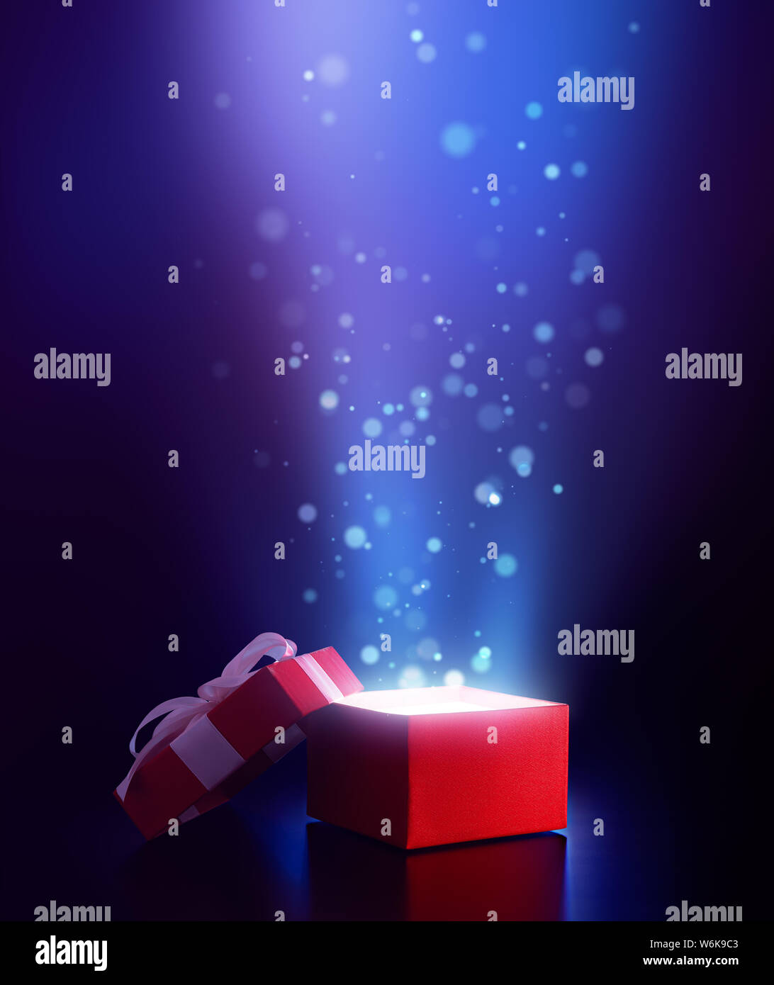 Red open gift box with magical light Stock Photo - Alamy