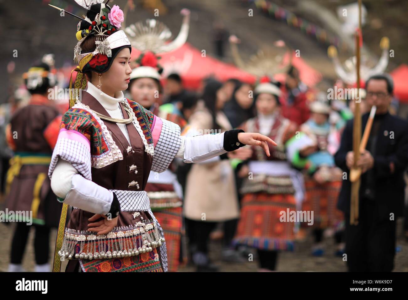 A Chinese girl of Miao ethnic minority dressed in traditional silver ...