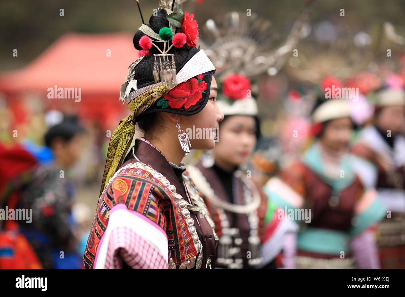 A Chinese girl of Miao ethnic minority dressed in traditional silver ...