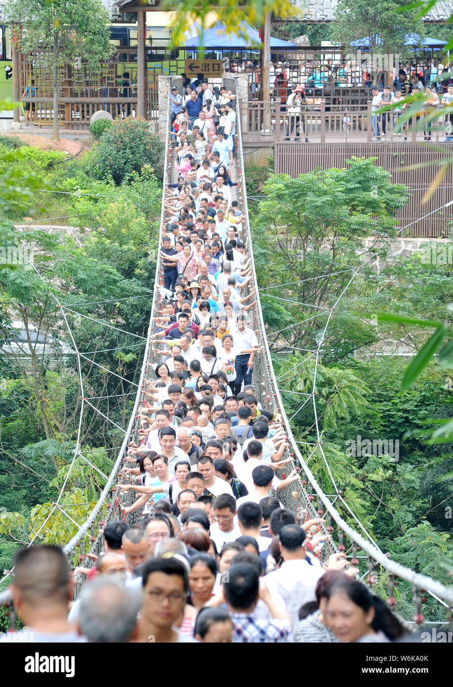 --FILE--Tourists crowd a bridge on a scenic spot during the National ...