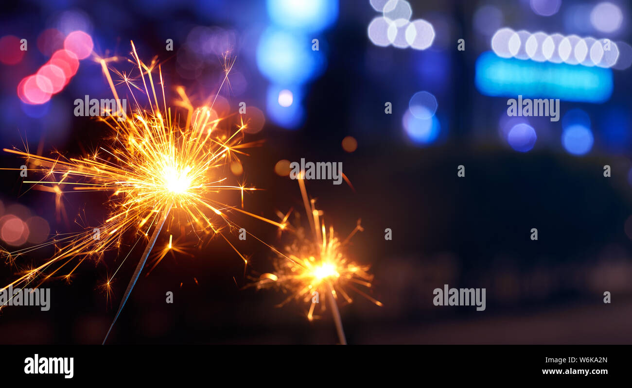 Sparkler with blurred street light background, Happy New Year Stock ...