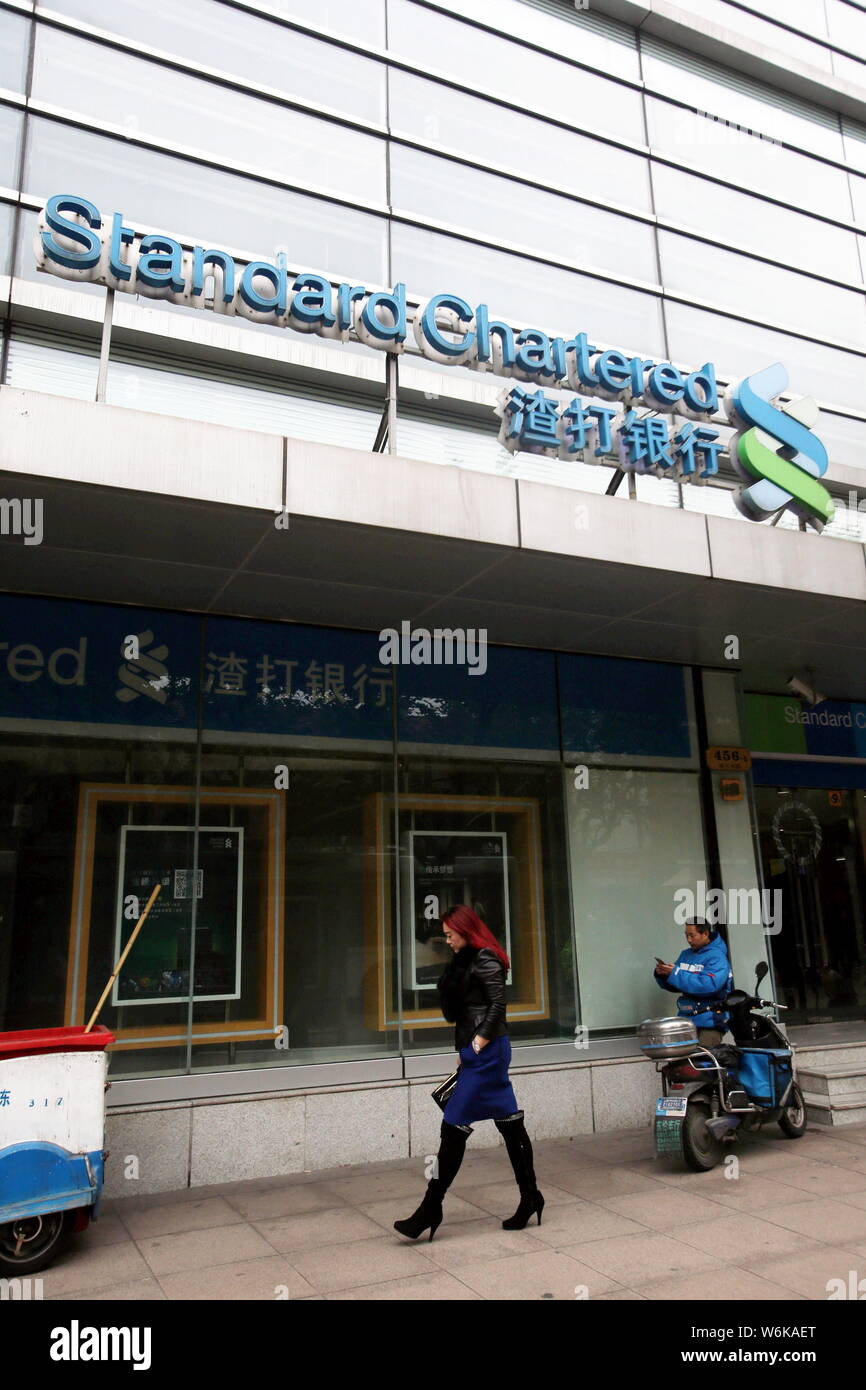 --FILE--Pedestrians walk past a branch of London-listed Standard ...