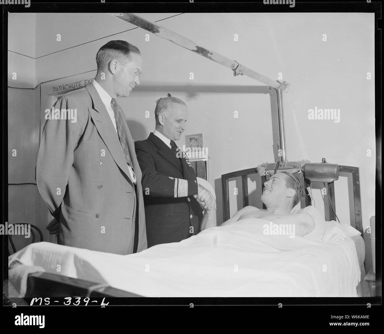 Rear Admiral Joel T. Boone shakes hands with Benny Phillips, miner ...