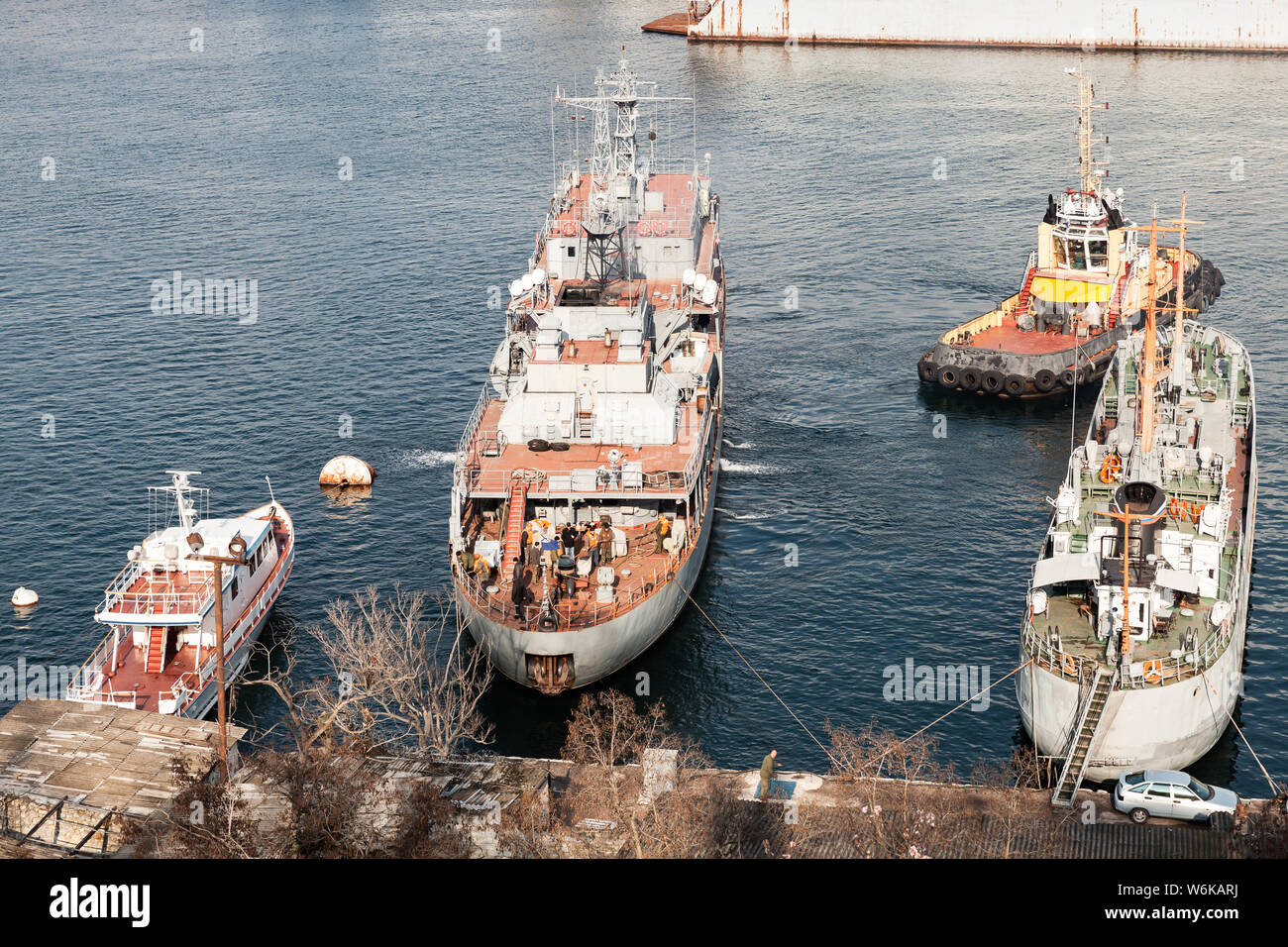 Military support vessel mooring operations with a tug in Yuzhnaya Bay ...