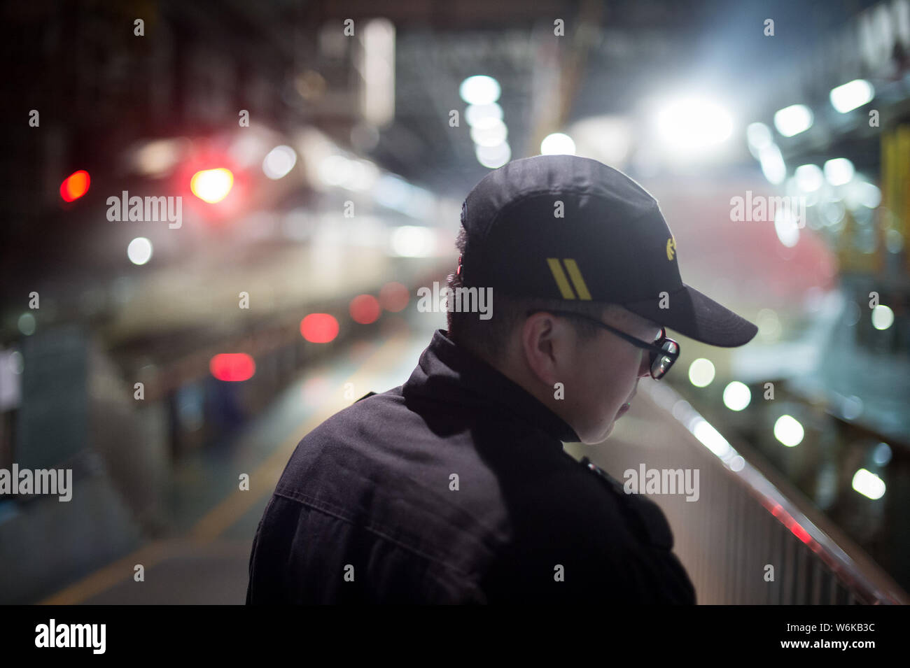 A Chinese worker checks a CRH (China Railway High-speed) bullet train ...