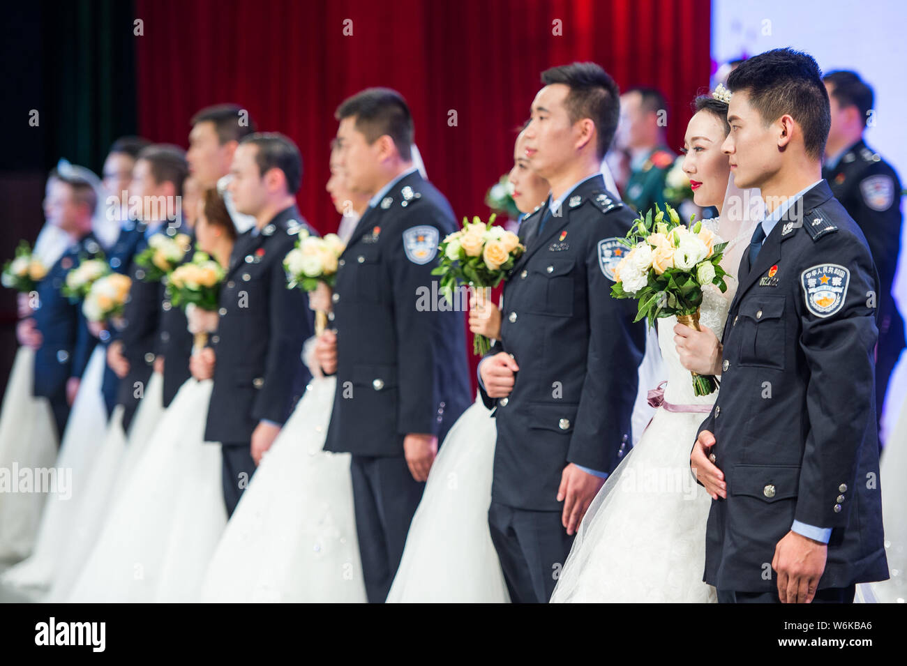 Police couples take part in a group wedding ceremony in Shenzhen city ...