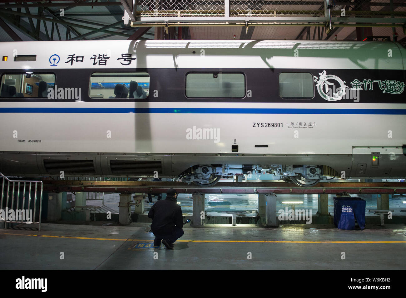 A Chinese worker checks a CRH (China Railway High-speed) bullet train ...