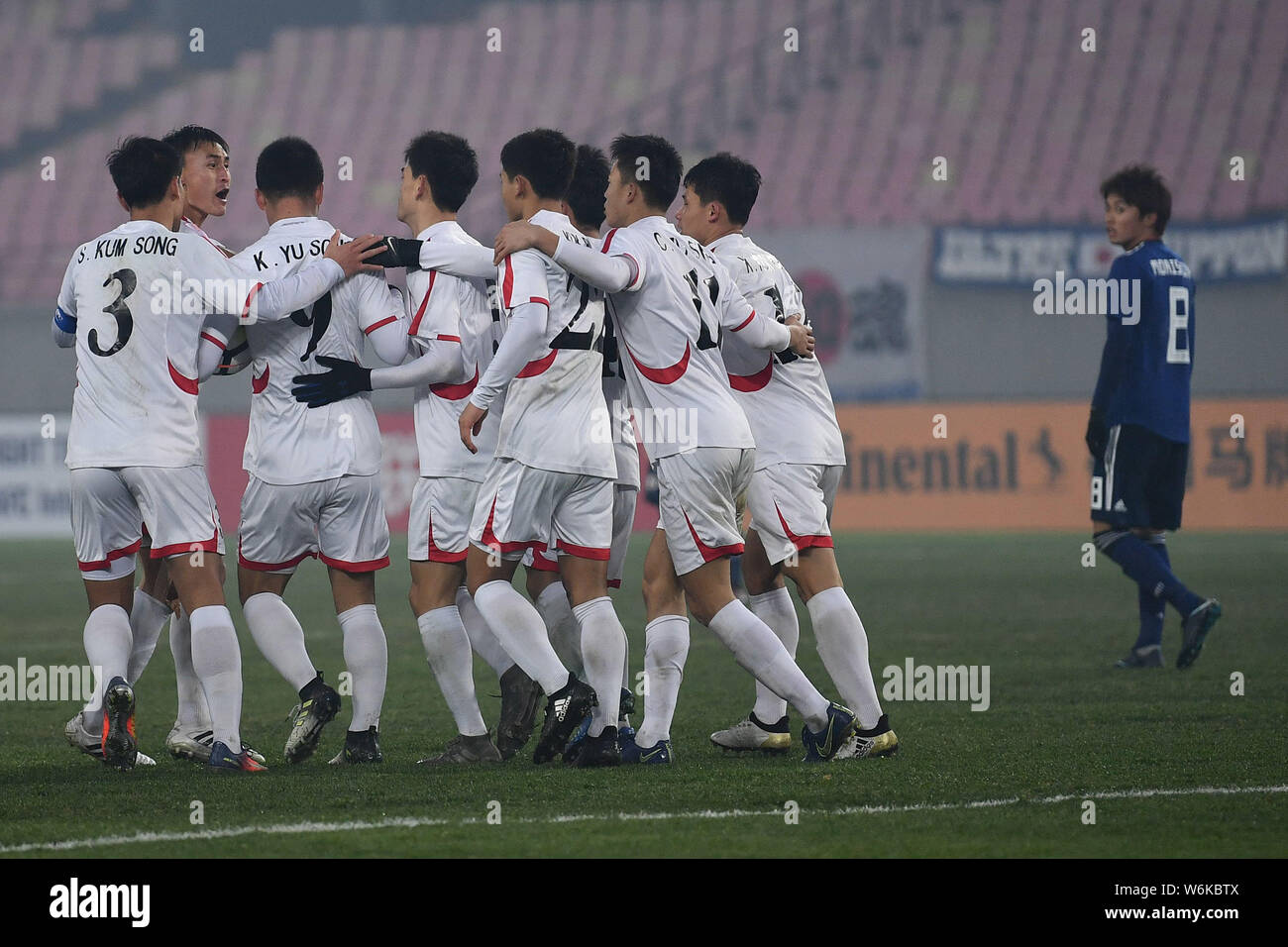 Players of North Korea celebrate after scoring a goal against Japan in their Group B match ...