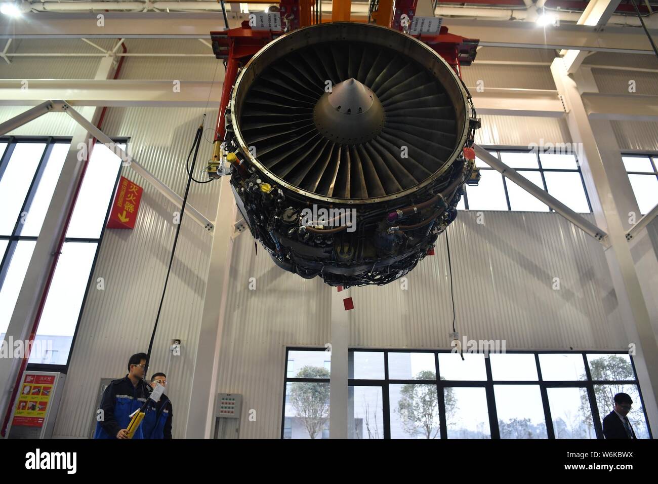 Chinese workers repair an aircraft engine at the Sichuan Services Aero ...