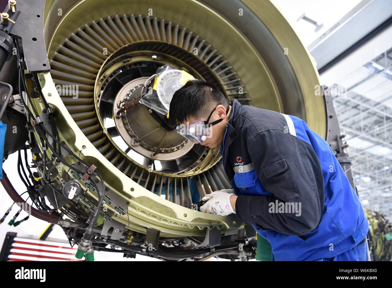 A Chinese worker repairs an aircraft engine at the Sichuan Services ...