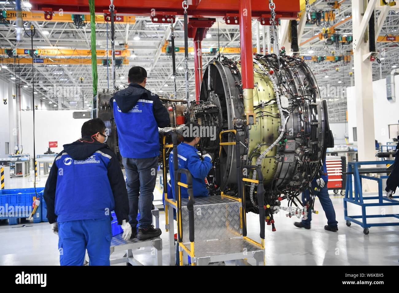 Chinese workers repair an aircraft engine at the Sichuan Services Aero ...