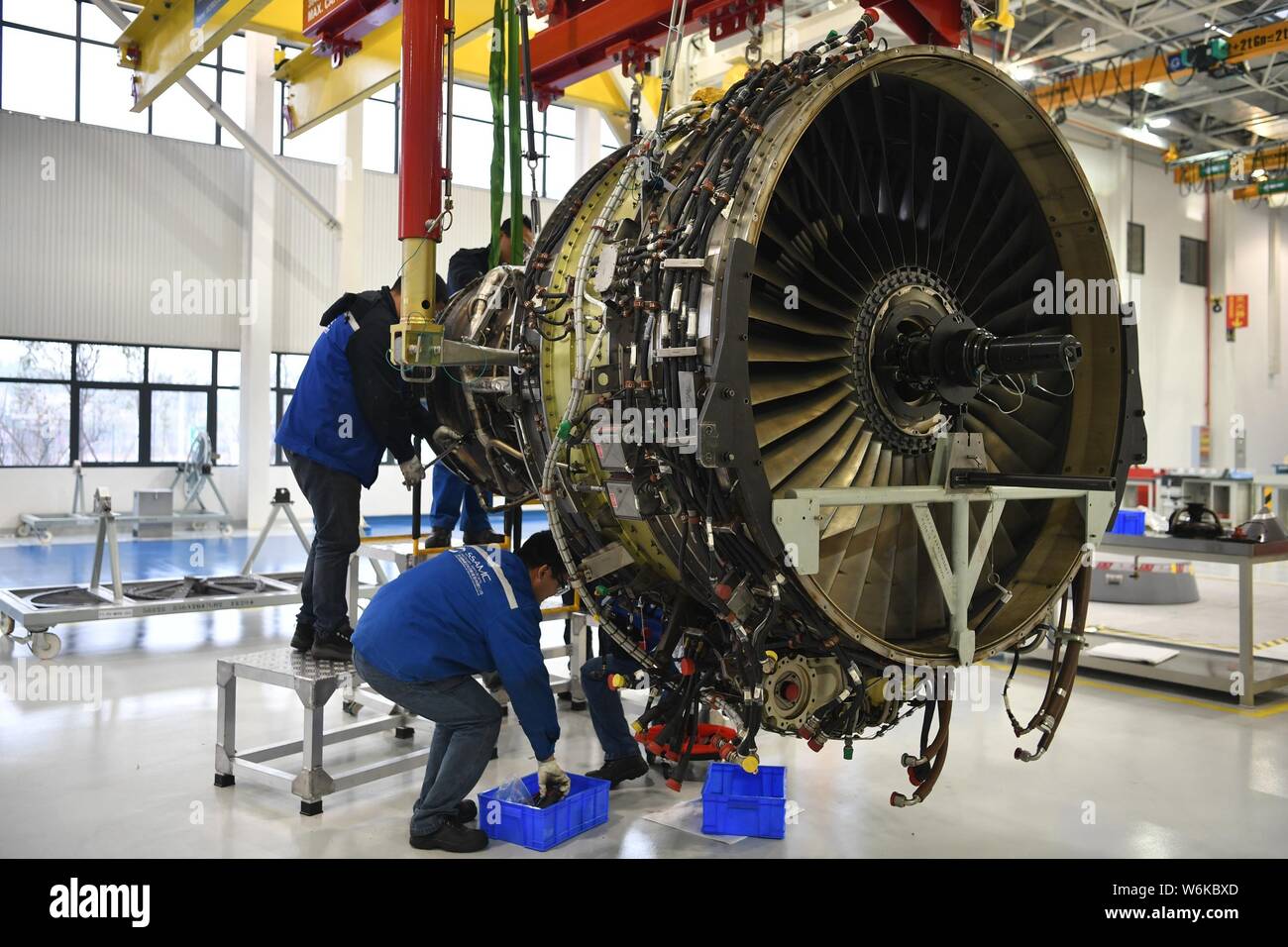 Chinese workers repair an aircraft engine at the Sichuan Services Aero ...