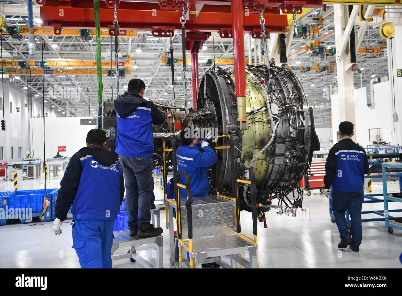Chinese workers repair an aircraft engine at the Sichuan Services Aero ...