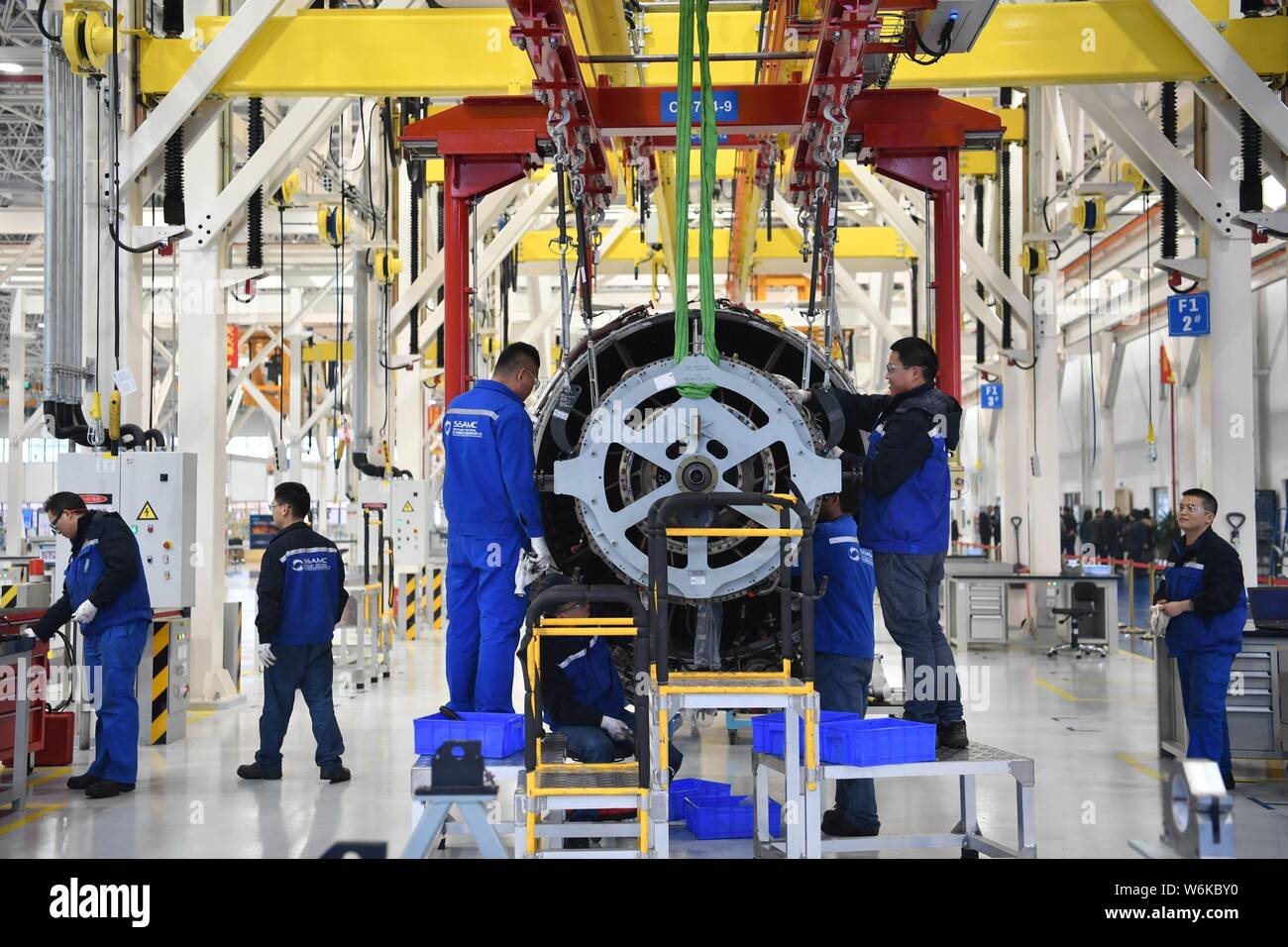 Chinese workers repair an aircraft engine at the Sichuan Services Aero ...