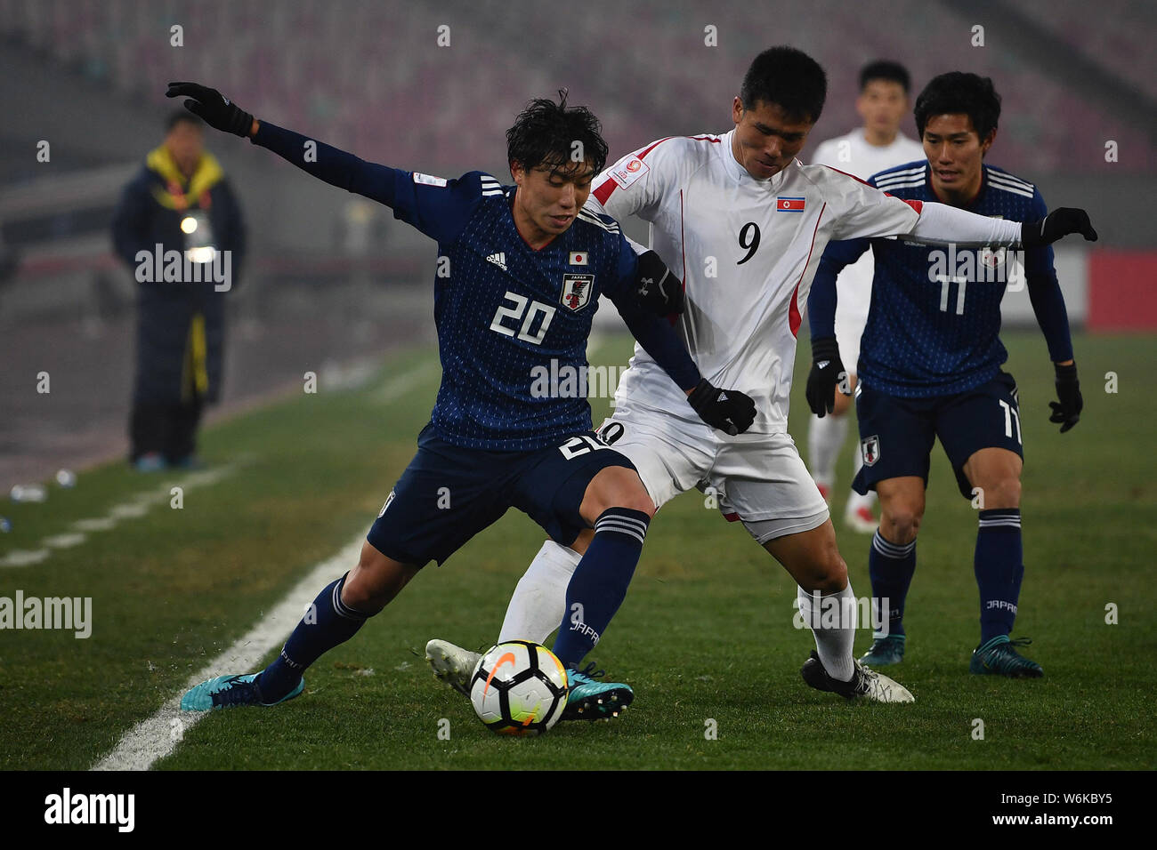 Taiyo Koga, left, and Keita Endo, right, of Japan challenge Kim Yu-song of North Korea in their ...