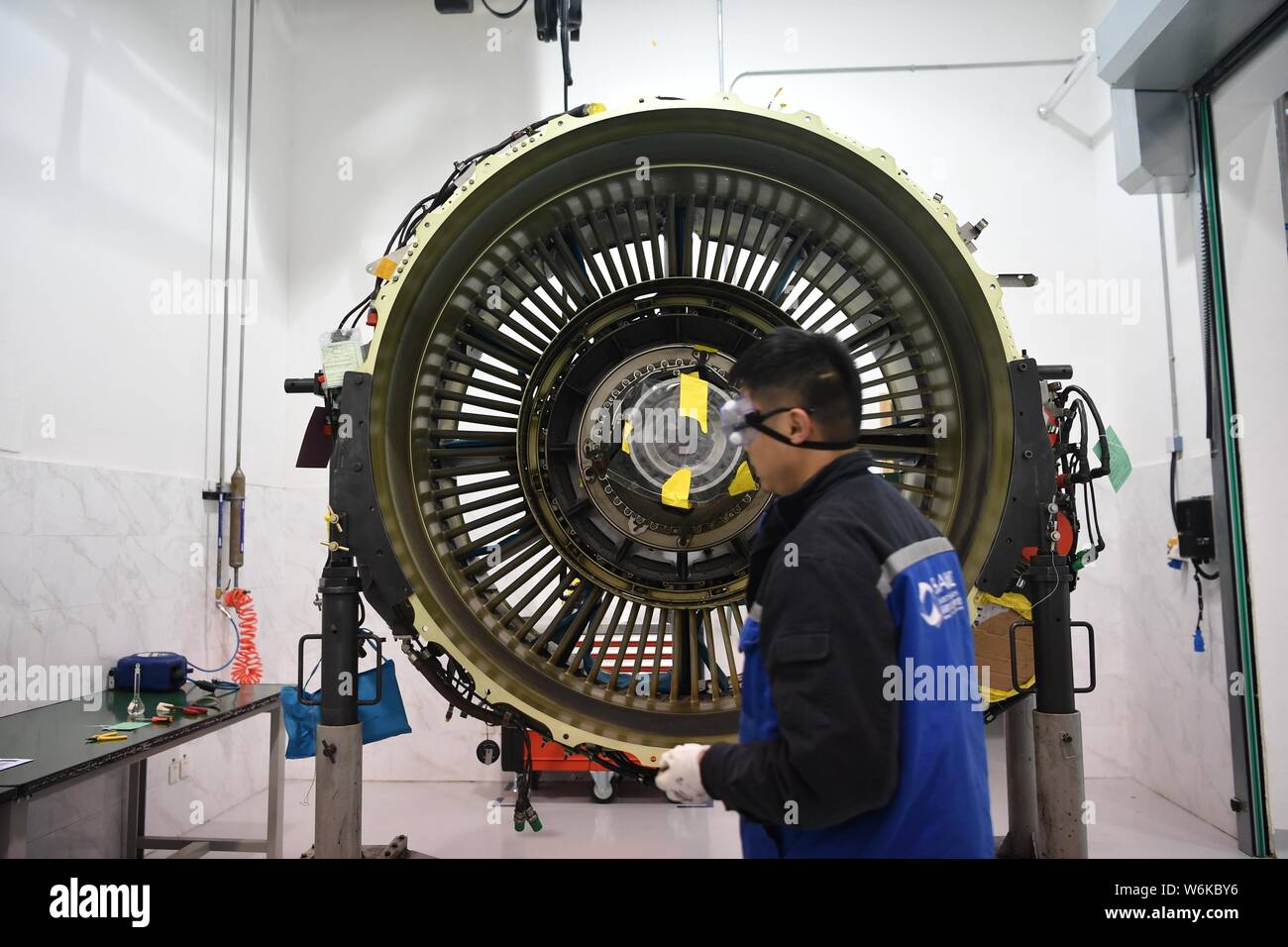 A Chinese worker repairs an aircraft engine at the Sichuan Services ...