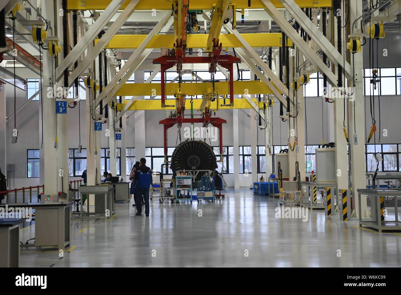 Chinese workers repair an aircraft engine at the Sichuan Services Aero ...