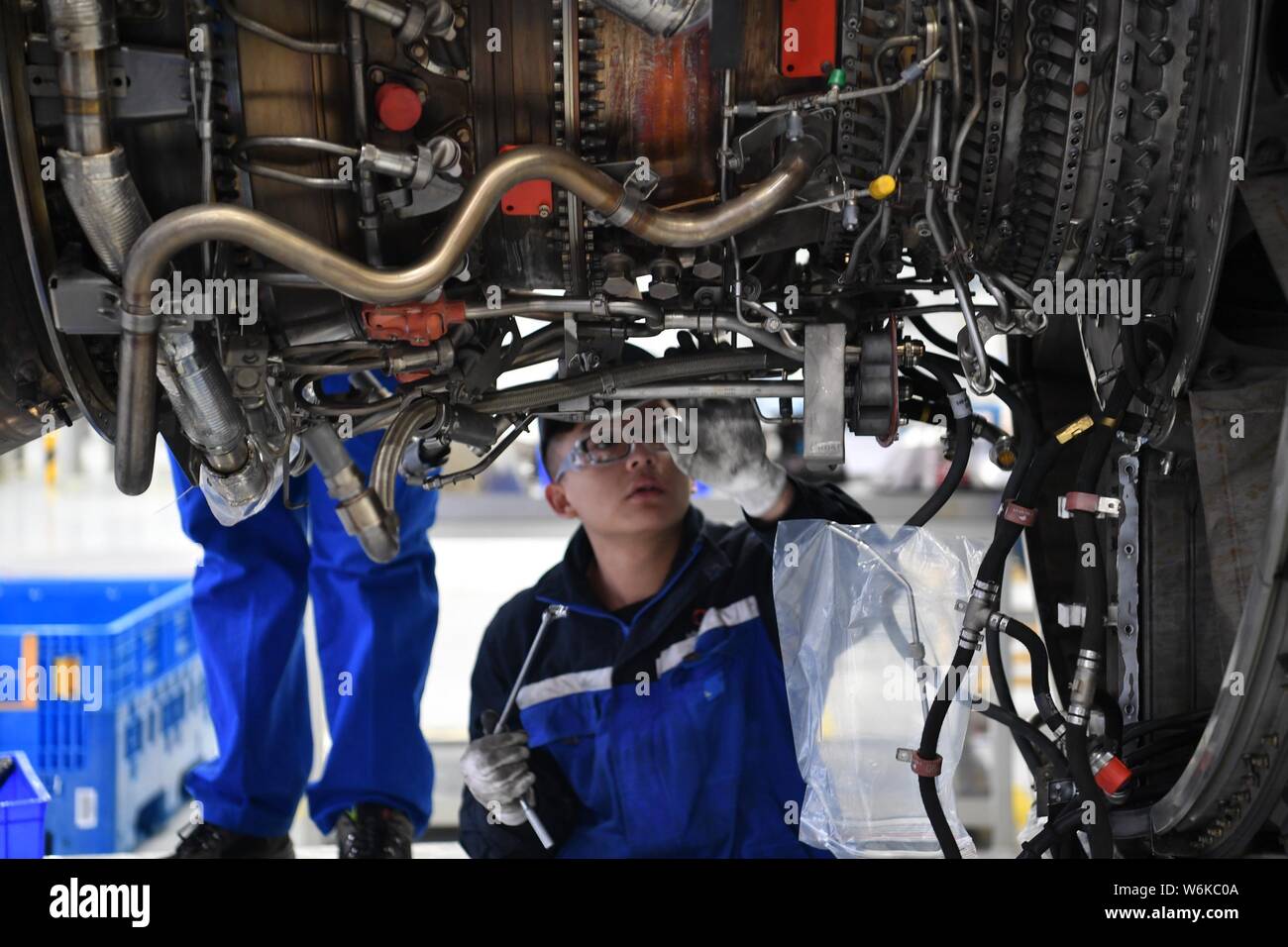 A Chinese worker repairs an aircraft engine at the Sichuan Services ...